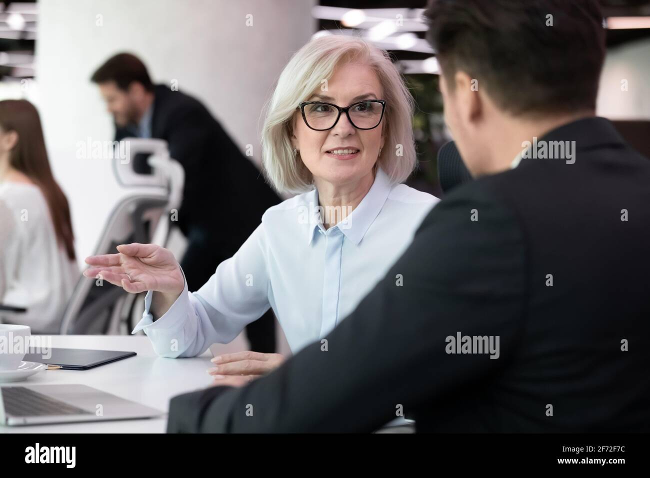 Diverse colleagues brainstorm at computer in office Stock Photo - Alamy