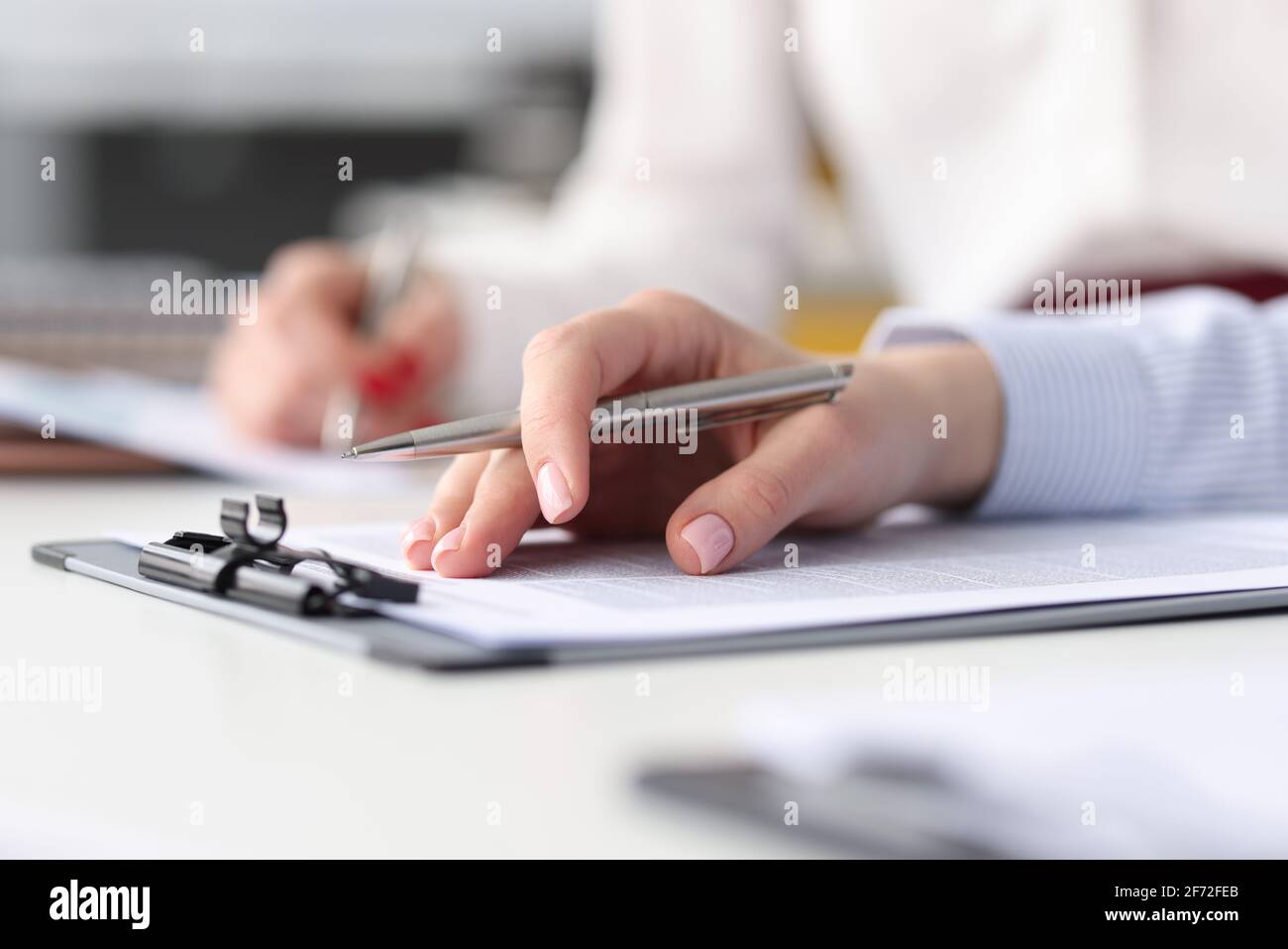 Clipboard pen hand table hi-res stock photography and images - Alamy