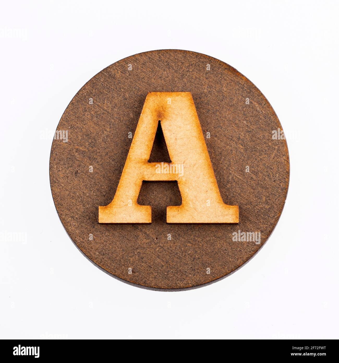 Letter A on a wood circle - Alphabet Stock Photo - Alamy