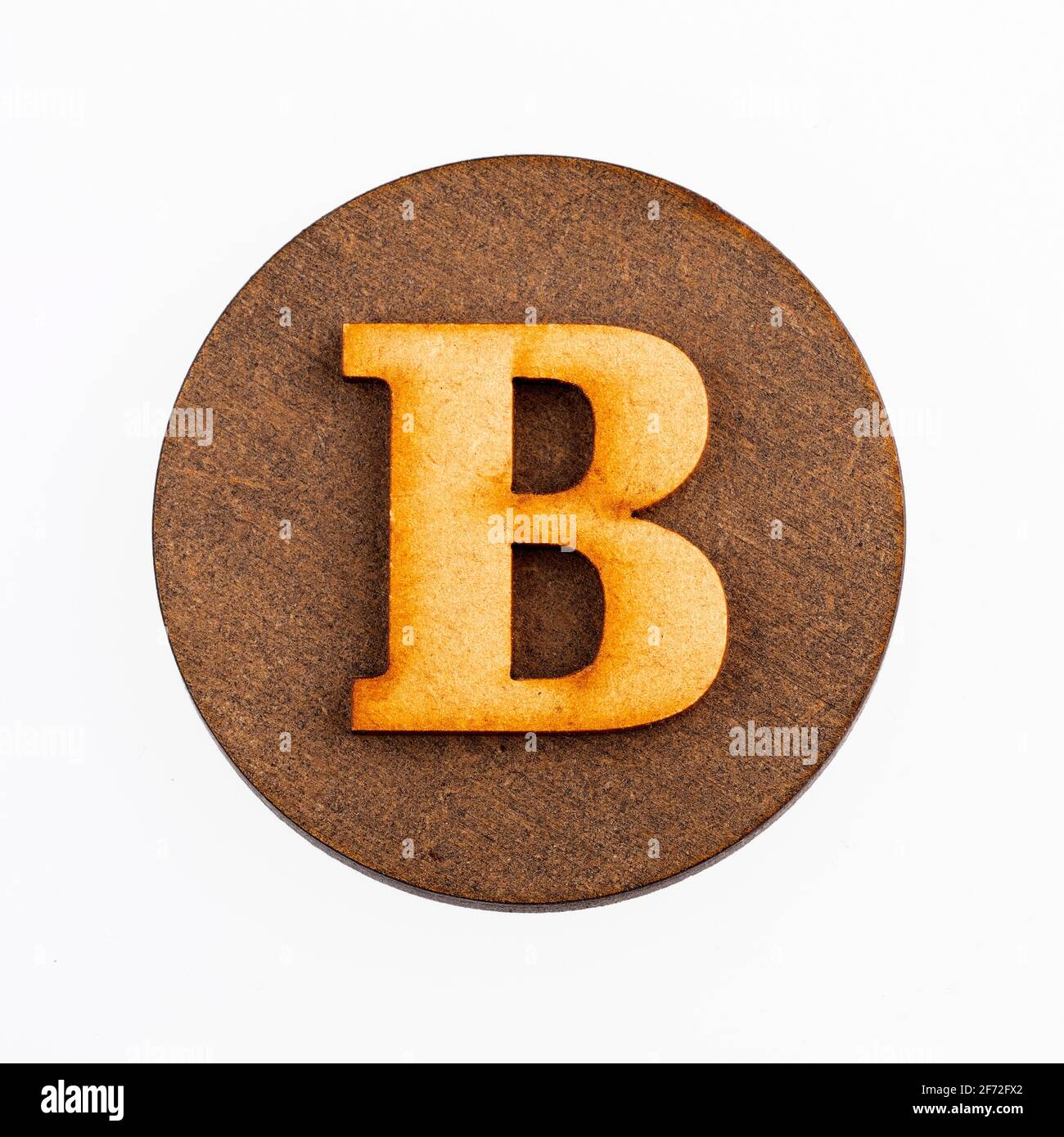 Letter B on a wood circle - Alphabet Stock Photo - Alamy