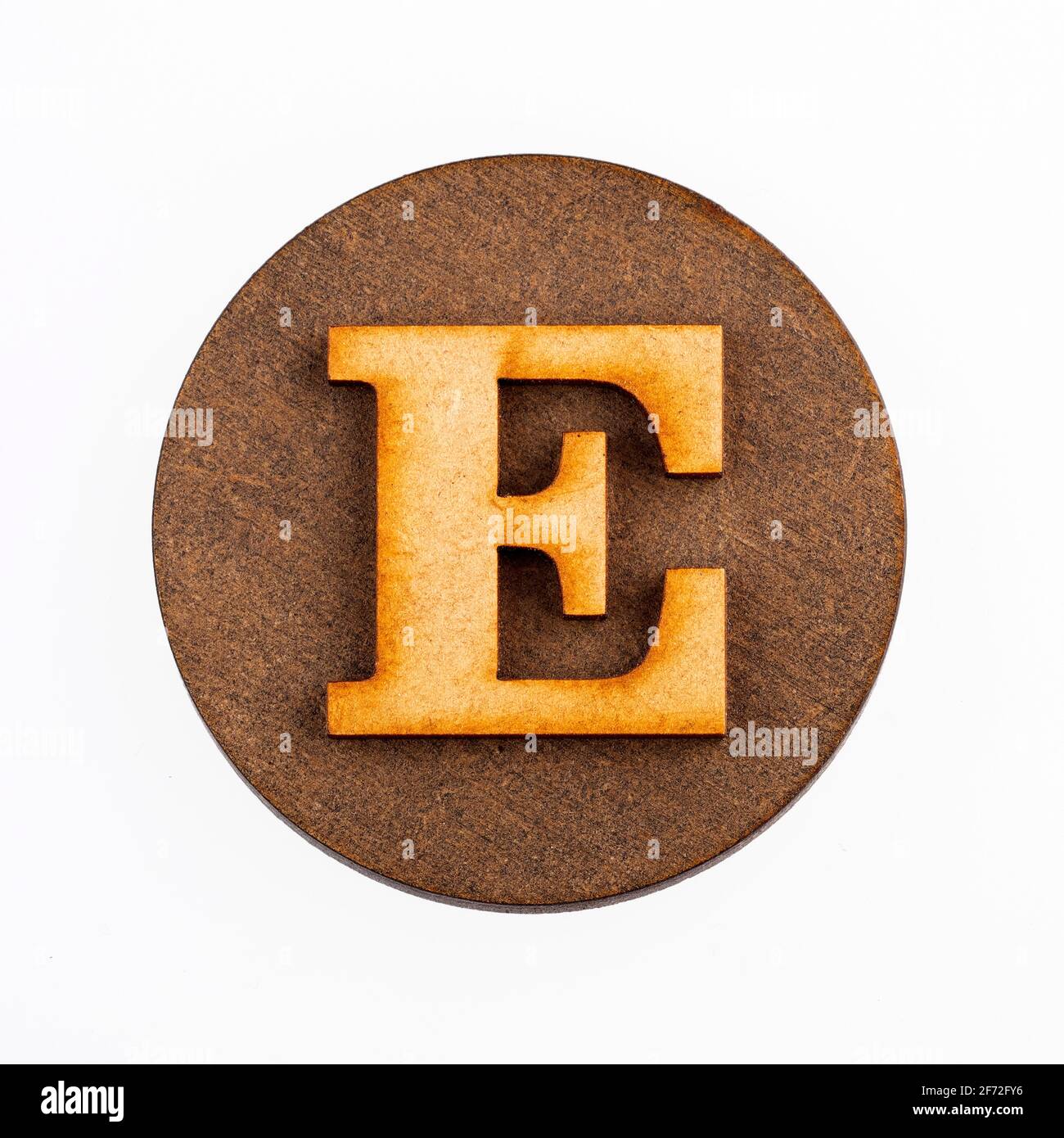 Letter E on a wood circle - Alphabet Stock Photo - Alamy