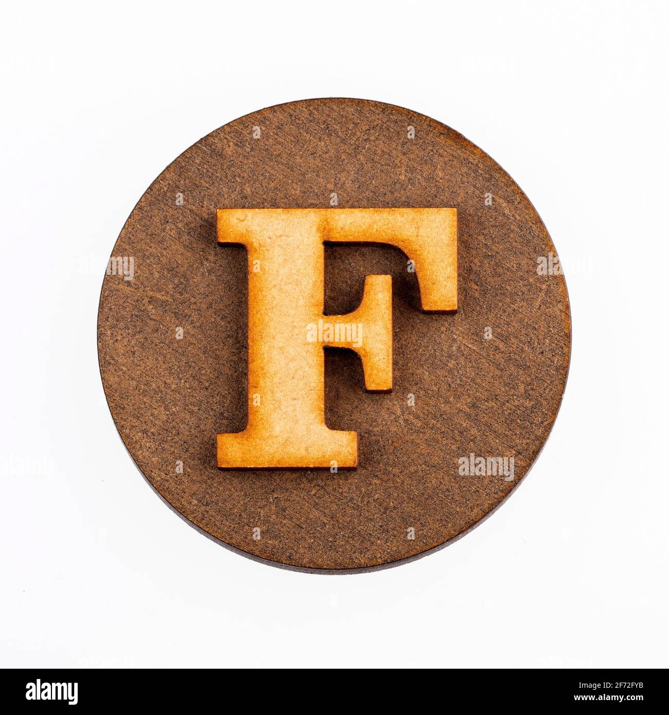 Letter F on a wood circle - Alphabet Stock Photo - Alamy
