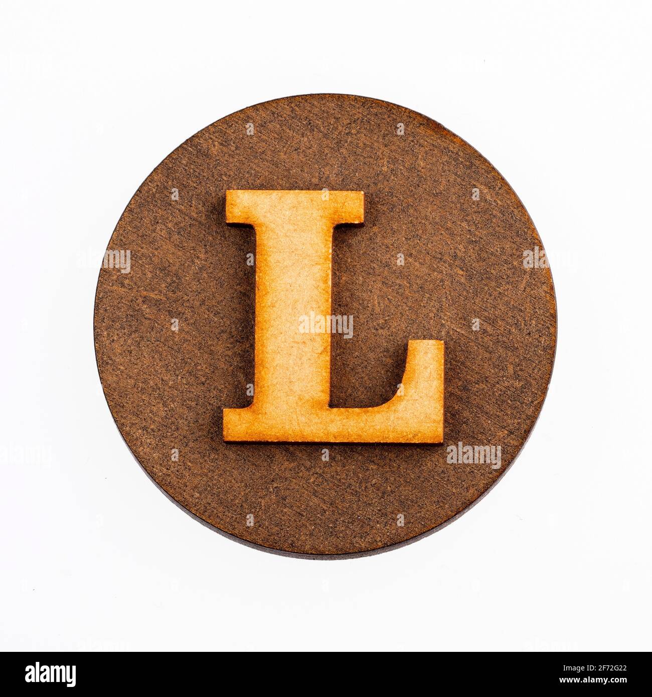 Letter L on a wood circle - Alphabet Stock Photo - Alamy
