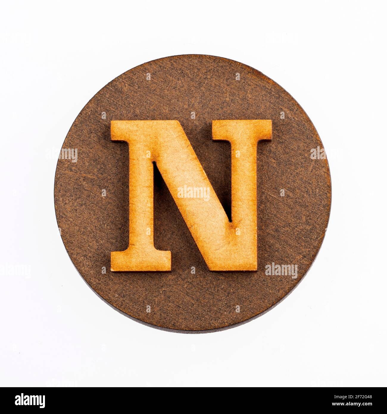 Letter N on a wood circle - Alphabet Stock Photo - Alamy