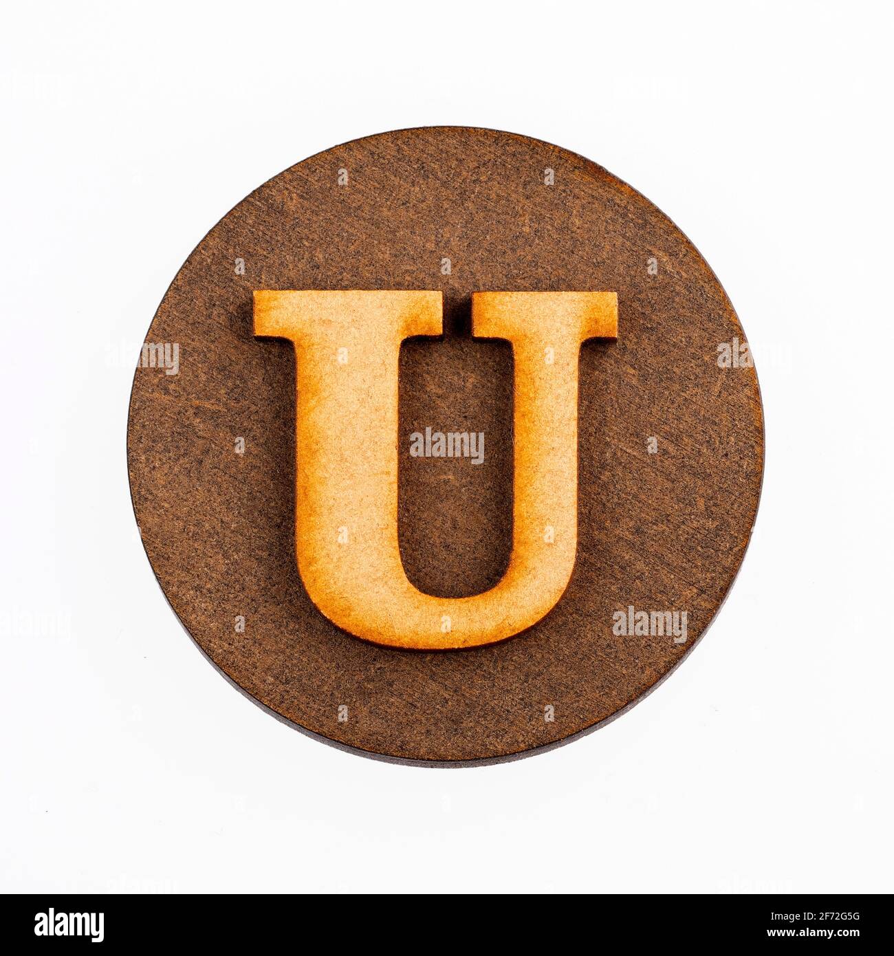 Letter U on a wood circle - Alphabet Stock Photo - Alamy