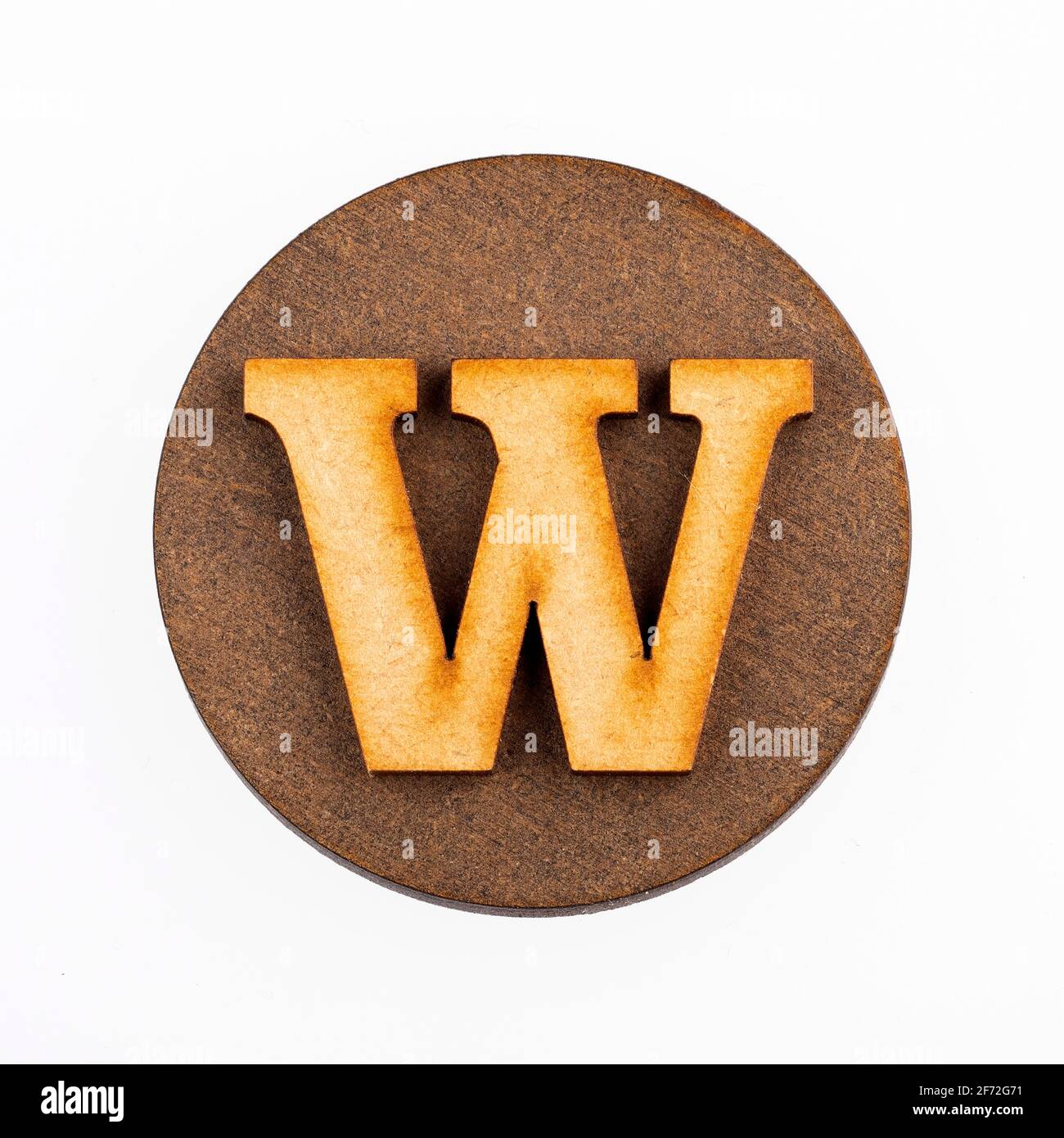 Letter W on a wood circle - Alphabet Stock Photo - Alamy