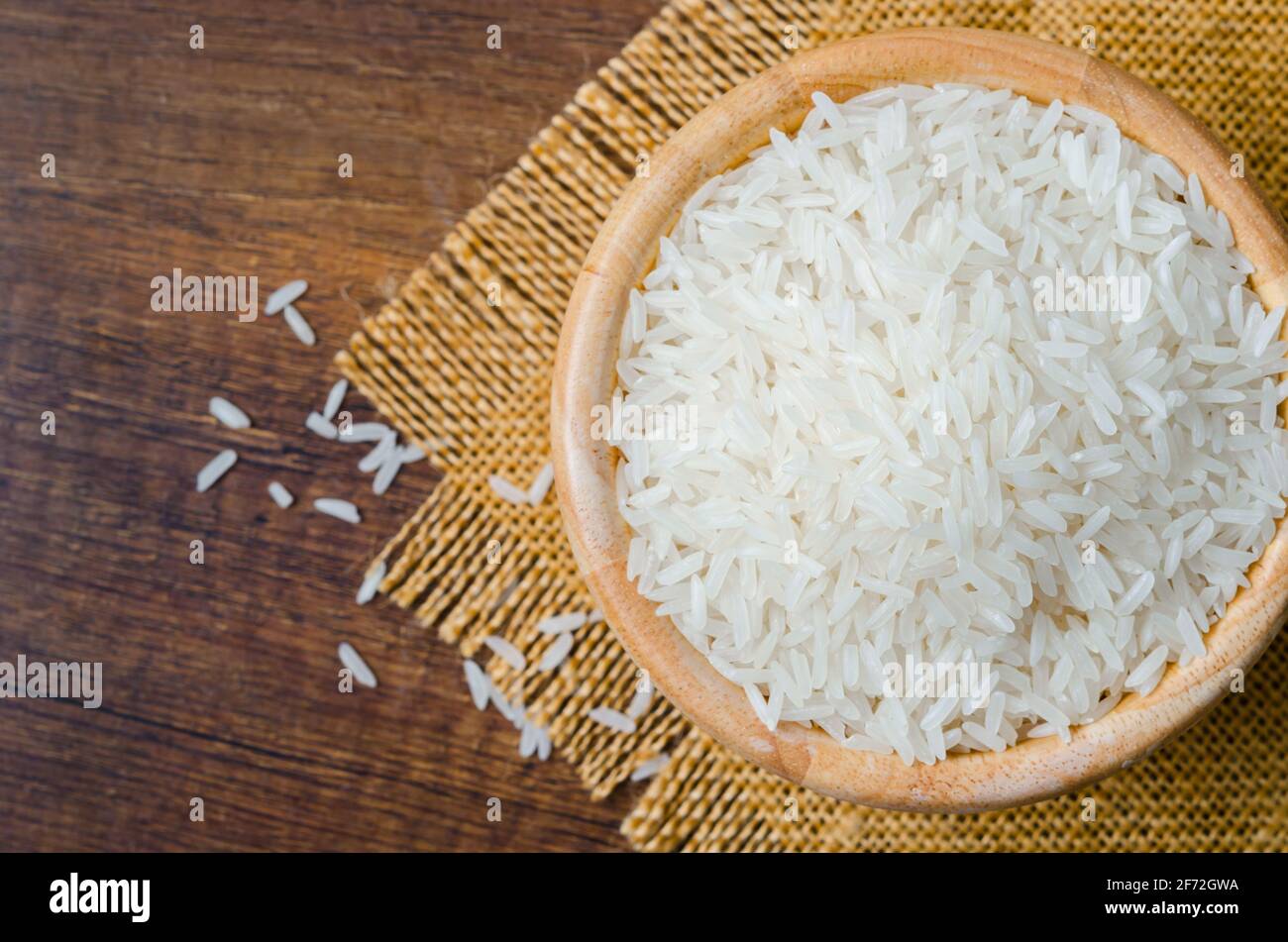 Organic Thai Jasmine rice grain in wooden bowl preparing for cooked ...