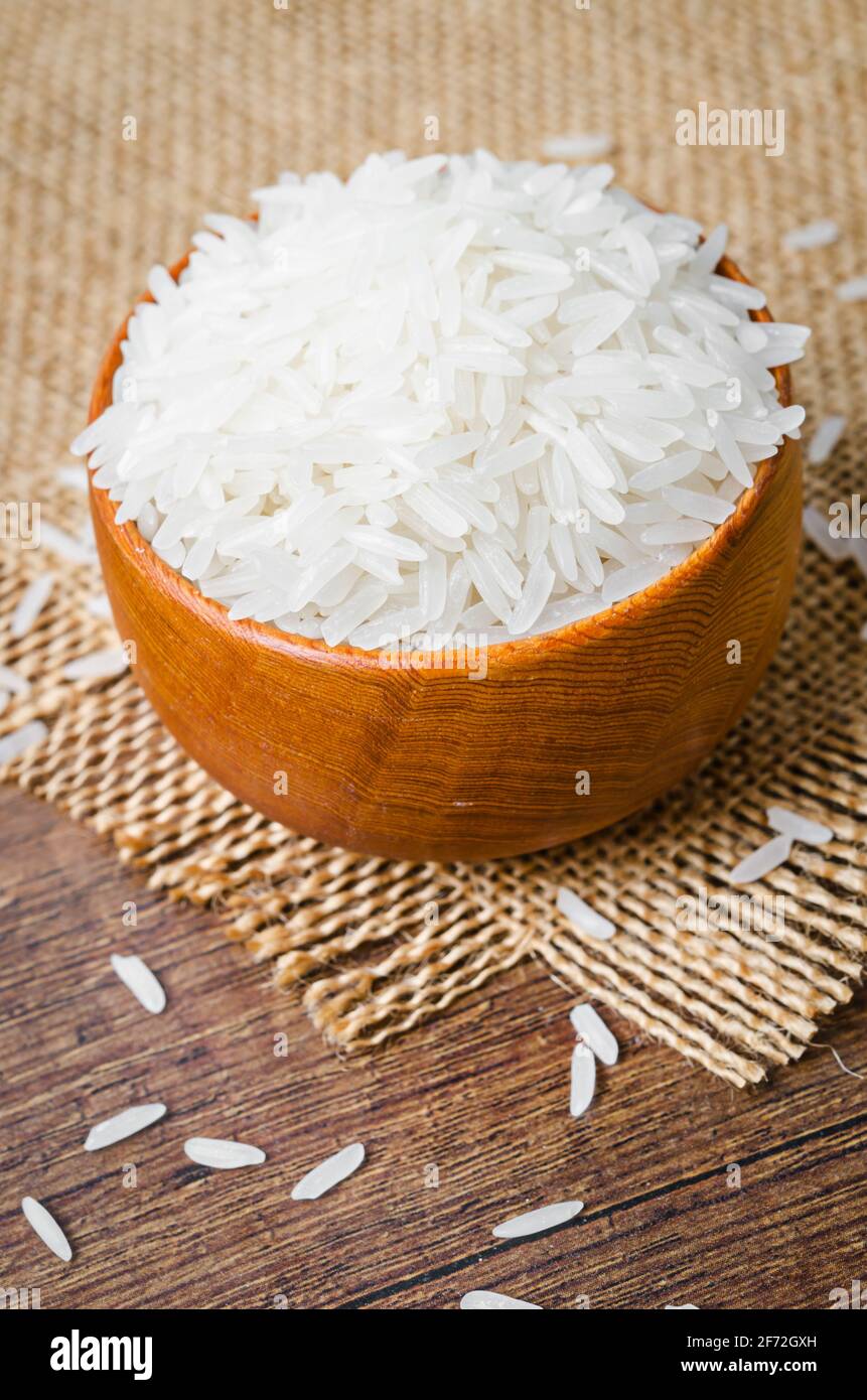 Organic Thai Jasmine rice grain in wooden bowl preparing for cooked ...