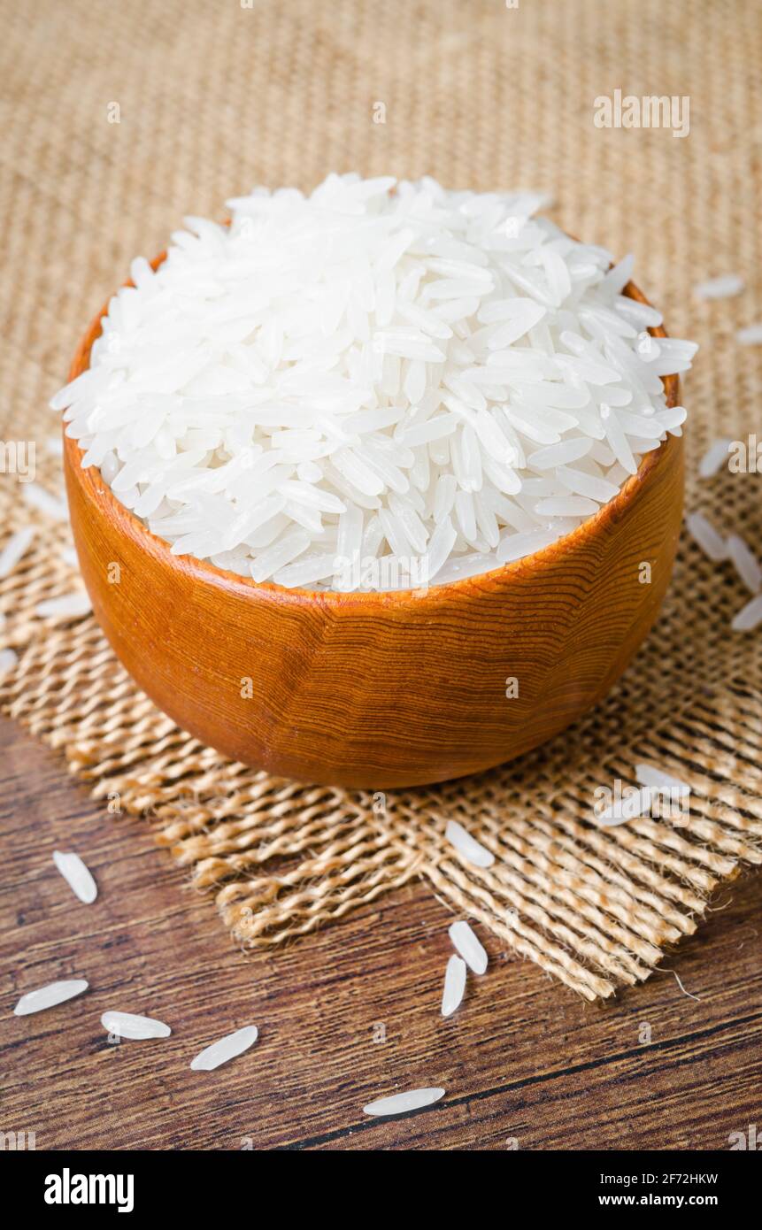 Organic Thai Jasmine rice grain in wooden bowl preparing for cooked ...