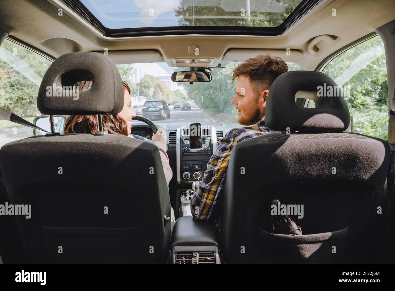 couple sitting in car driving to travel destination sharing concept ...