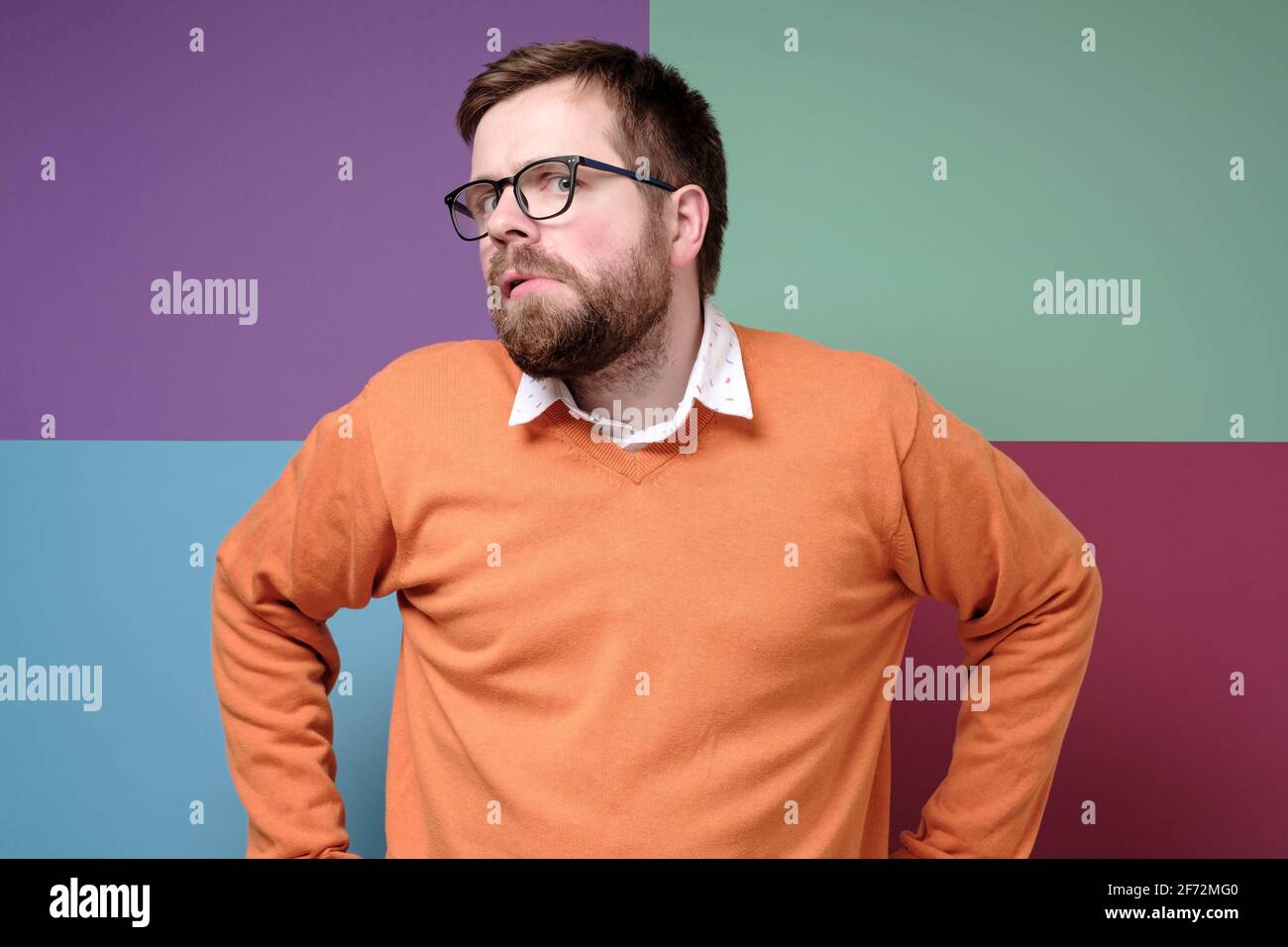 Strange Caucasian man looks suspiciously and incredulously to the side ...