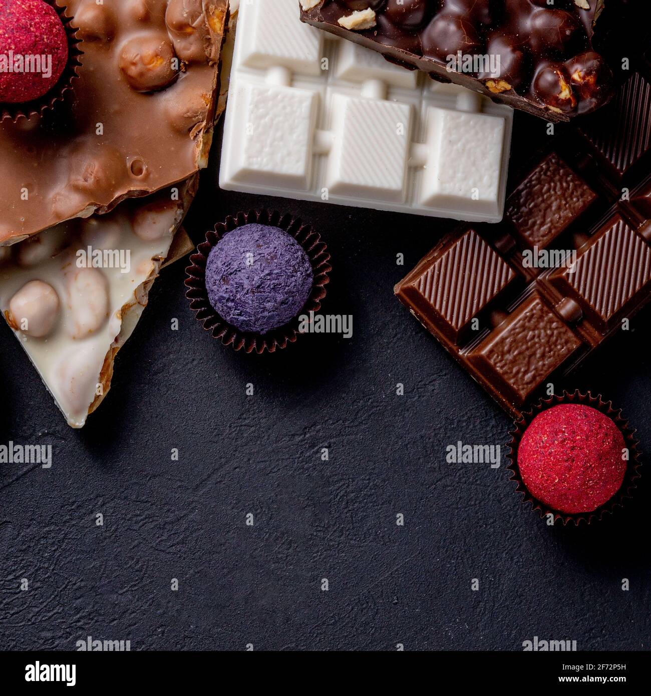 Chocolate bar, crushed pieces of dark chocolate and nuts. Praline ...