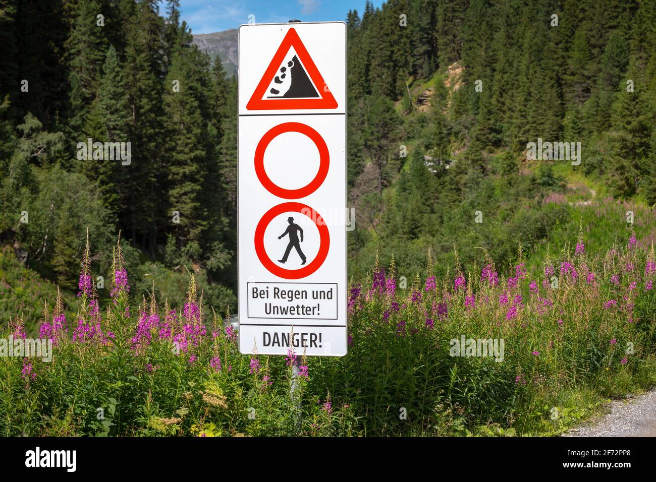 Warning sign for danger in rain and storms along the hiking area ...