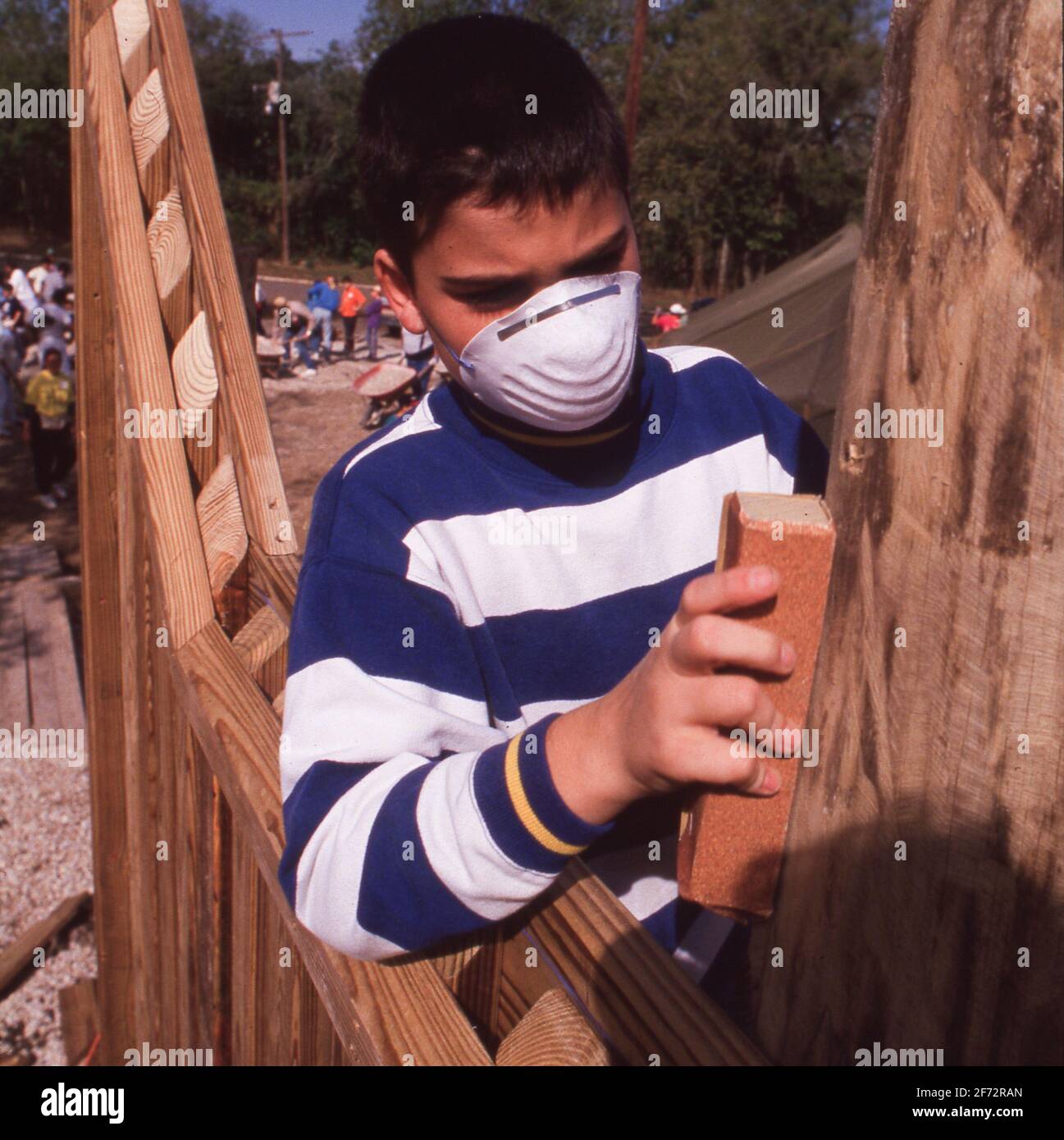 San Marcos, TX USA: Hispanic boy concentrates on sanding wood board ...