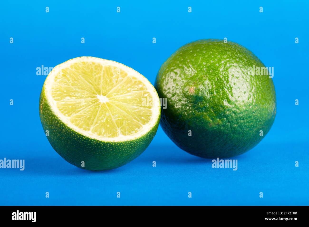 Tahiti lemon on blue background - Citrus × latifolia Stock Photo - Alamy