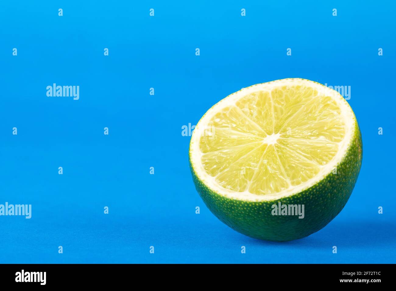 Tahiti lemon on blue background - Citrus × latifolia Stock Photo - Alamy