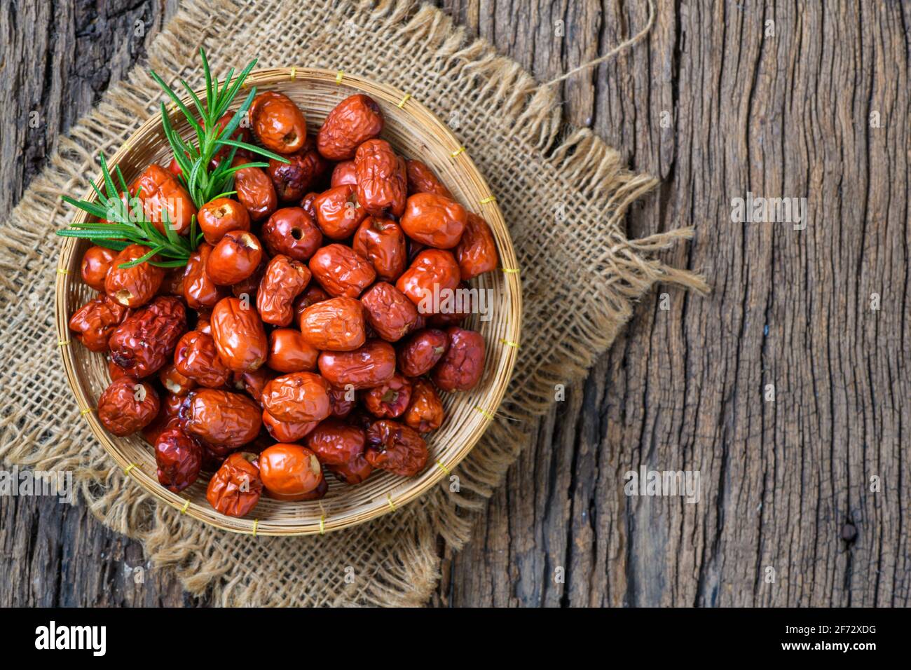 Dried Jujube, Chinese dried red date fruit in bamboo basket on old wood ...