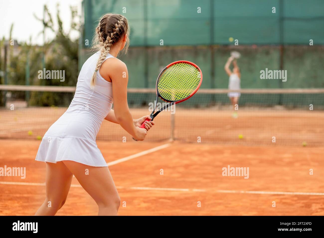 Professional tennis player playing tennis on a clay tennis court on a ...