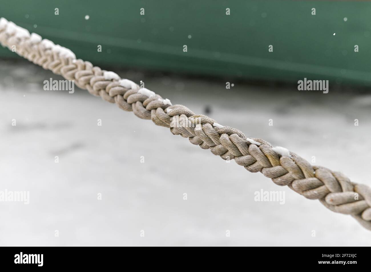 Rope tied ship on background of green ship side. Ropes hanging from ...
