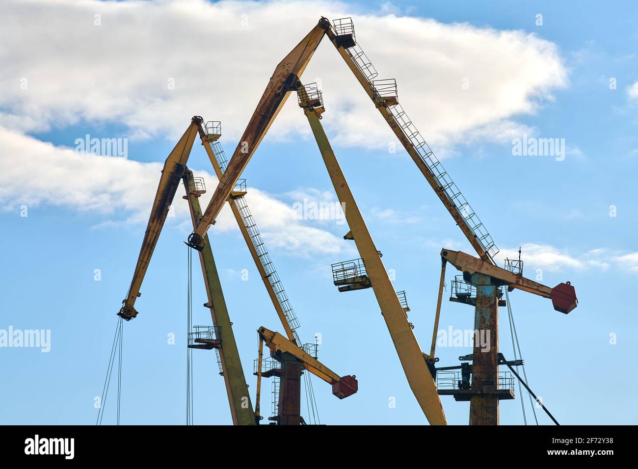 Massive harbor cranes in seaport. Heavy load dockside cranes in port ...