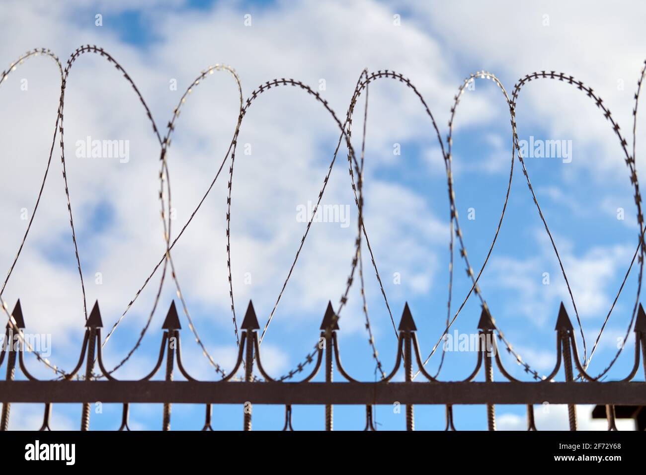 Barbed wire on fence, steel grating fence, metal fence wire. Coiled ...