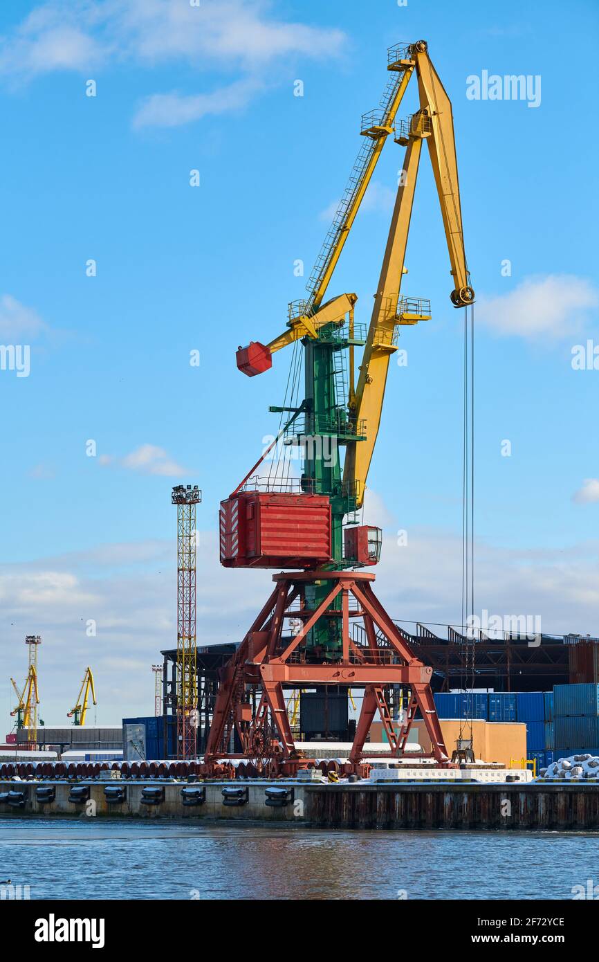 Massive harbor cranes in seaport. Heavy load dockside cranes in port ...