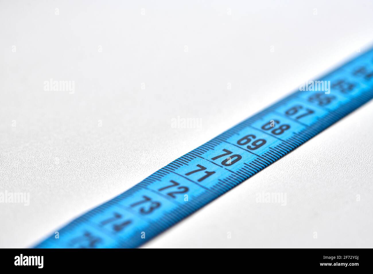 Blue measuring tape isolated on white background Stock Photo - Alamy