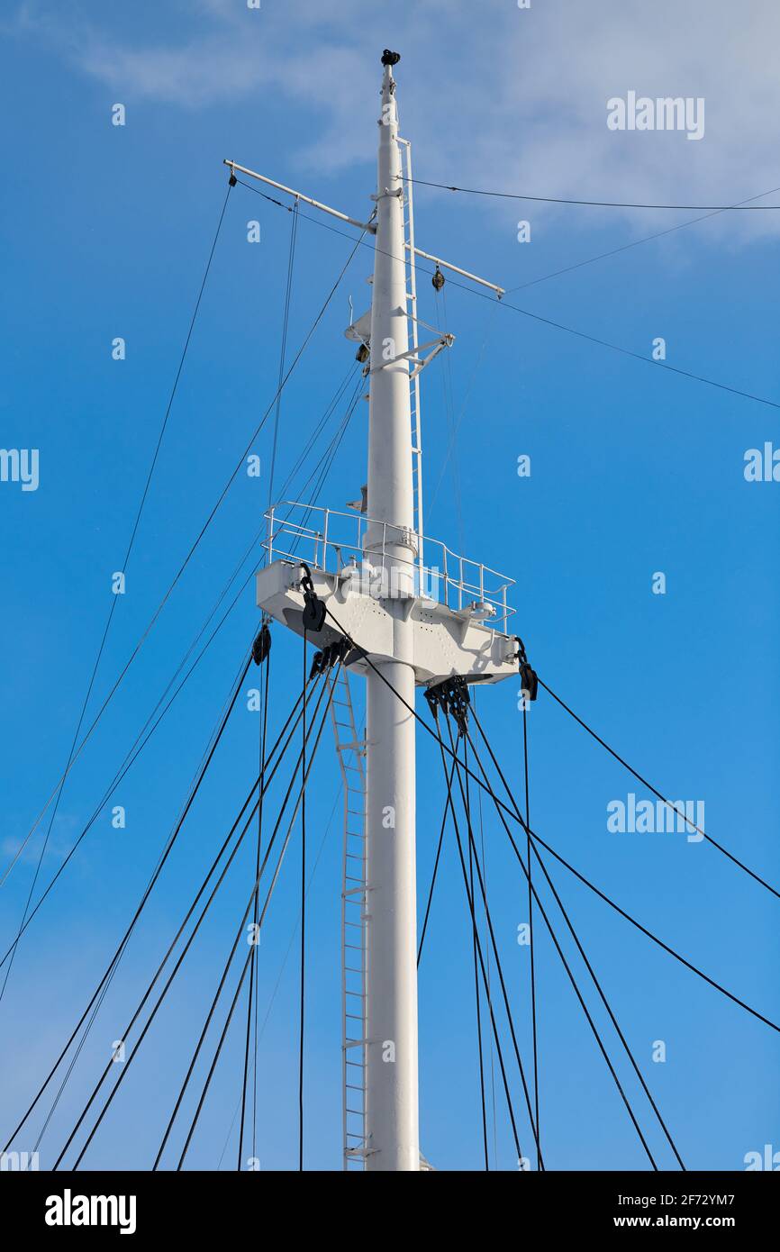 Sailing mast of ship on blue cloudy sky background, copy space. Sailing ...