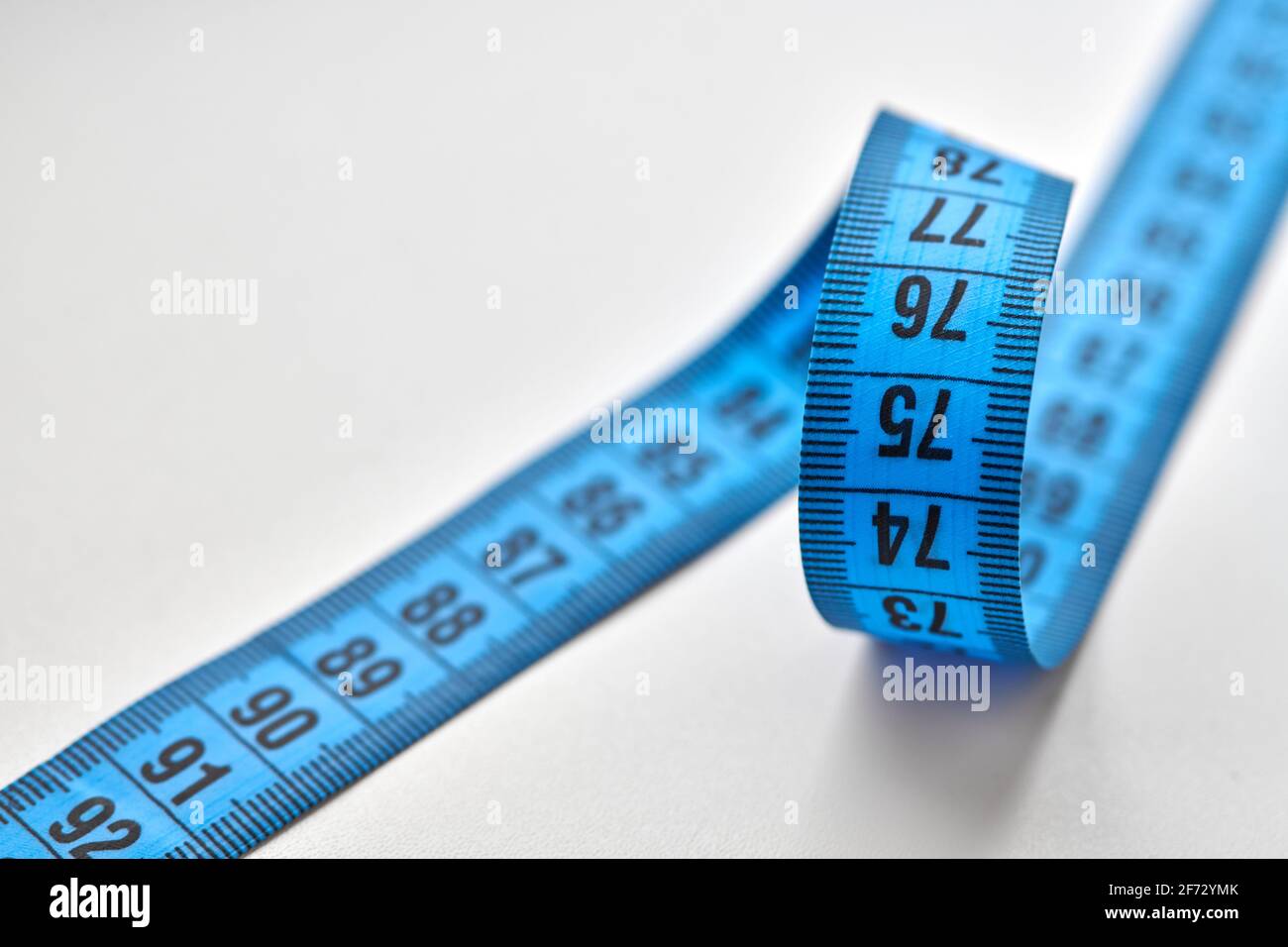 Blue measuring tape isolated on white background Stock Photo - Alamy