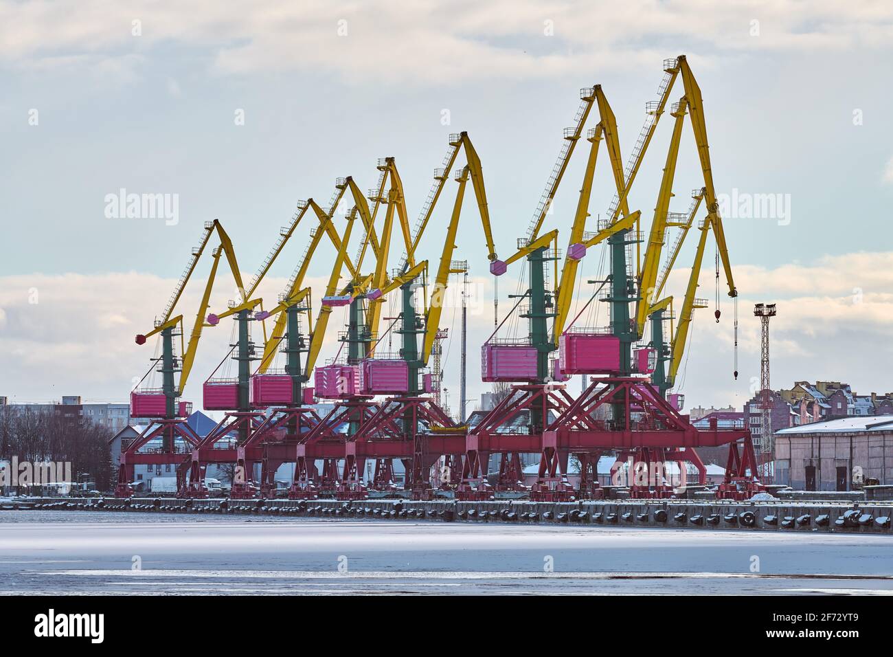 Massive harbor cranes in seaport. Heavy load dockside cranes in port ...