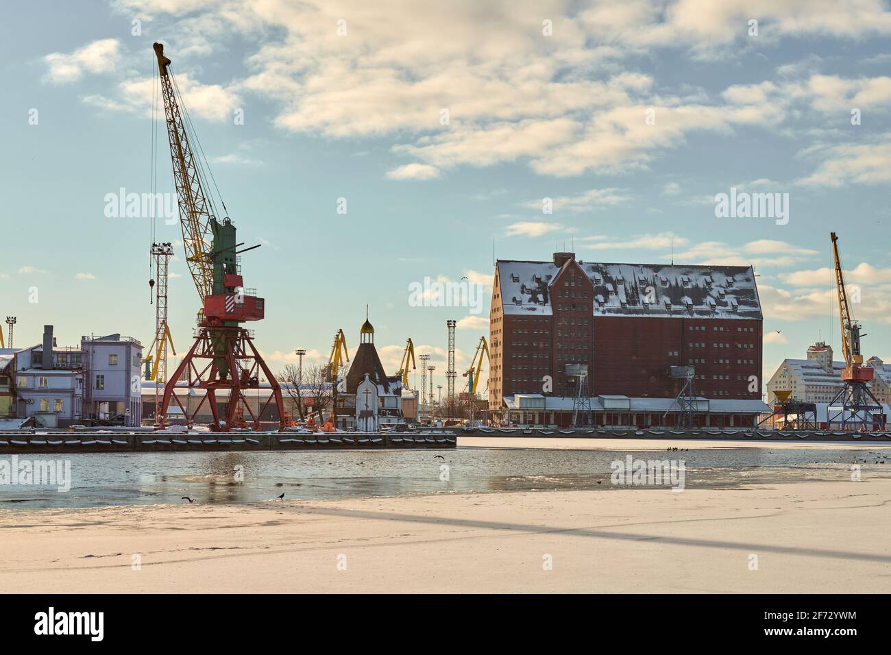Massive harbor cranes in seaport. Heavy load dockside cranes in port ...