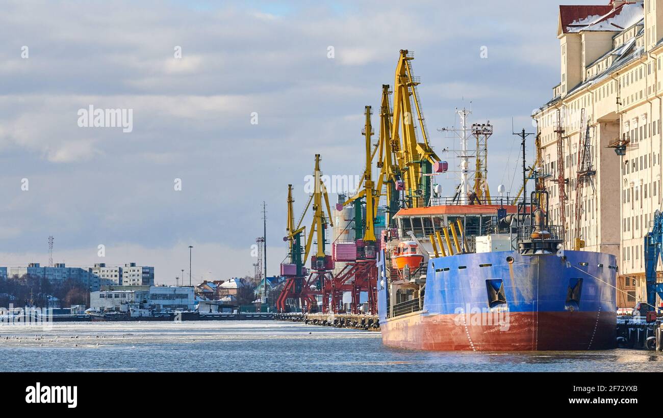 Moored cargo ships and harbor cranes in port. Seaport, cargo container ...