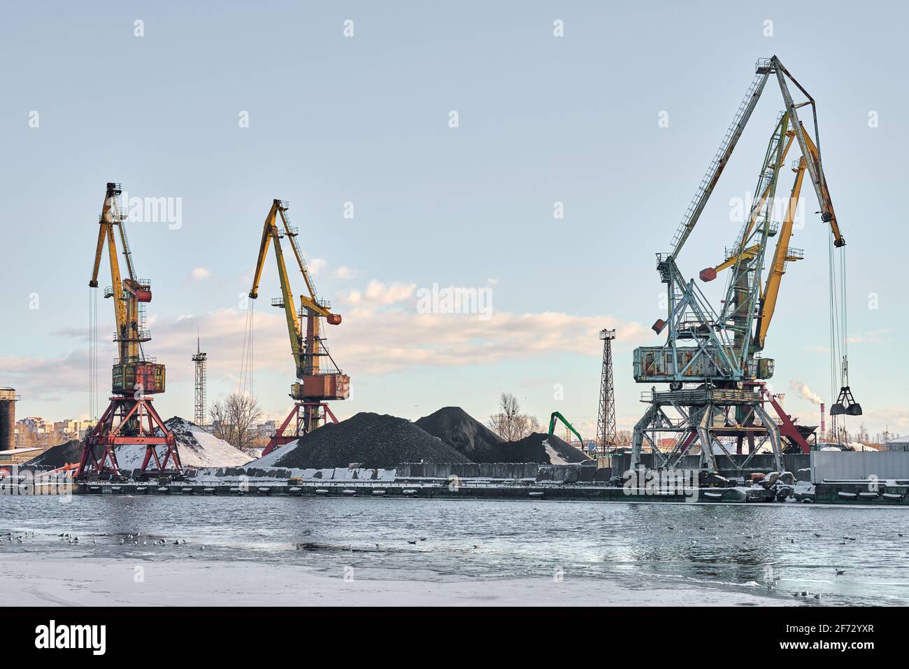 Massive harbor cranes in seaport. Heavy load dockside cranes in port ...