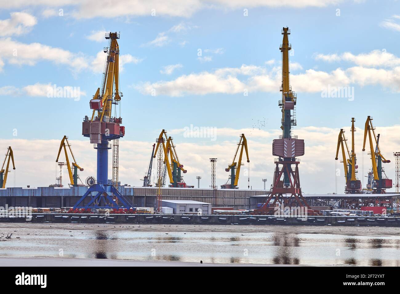 Massive harbor cranes in seaport. Heavy load dockside cranes in port ...