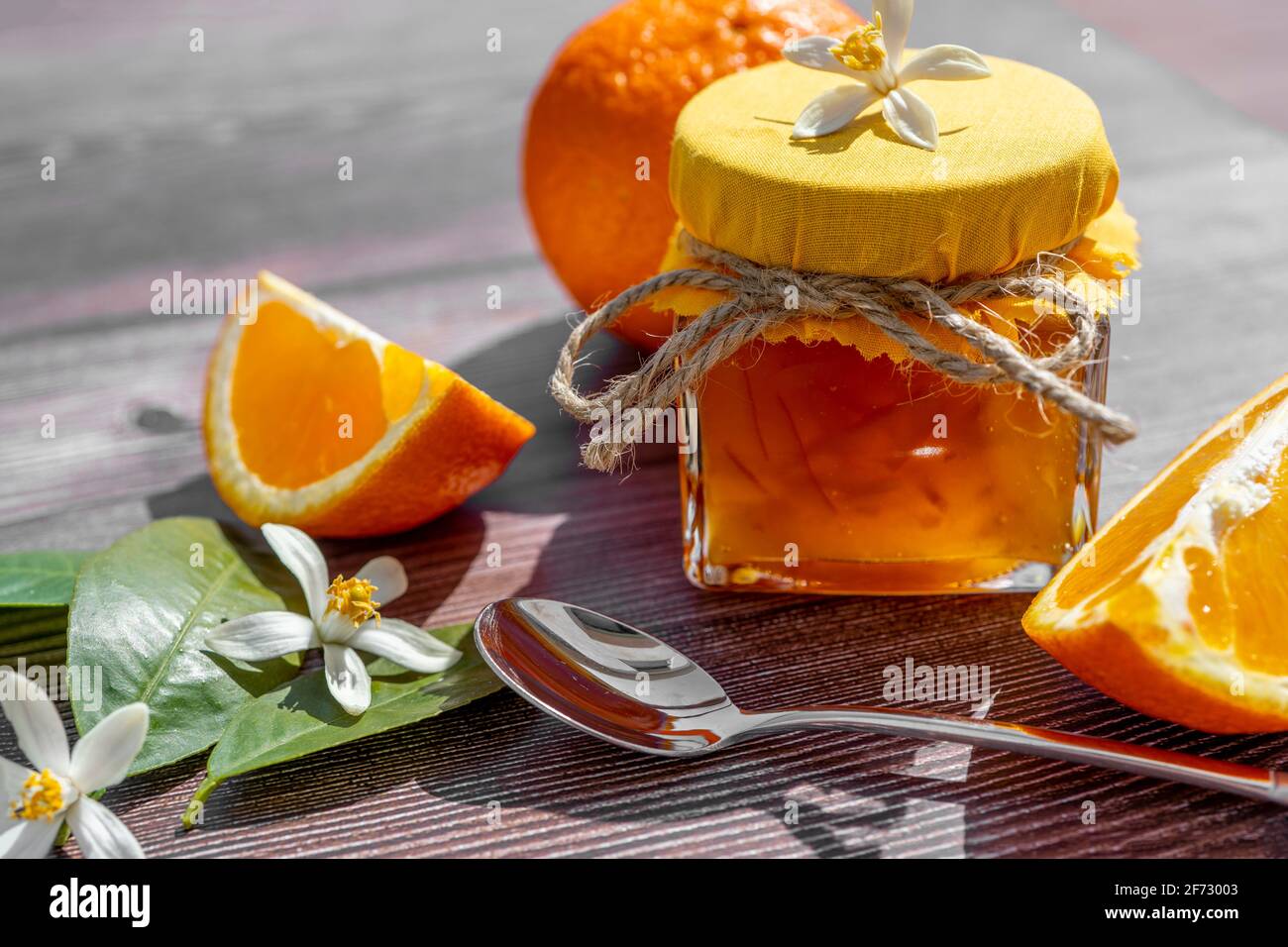 Traditional arrangement of orange jam with fresh orange fruits on ...