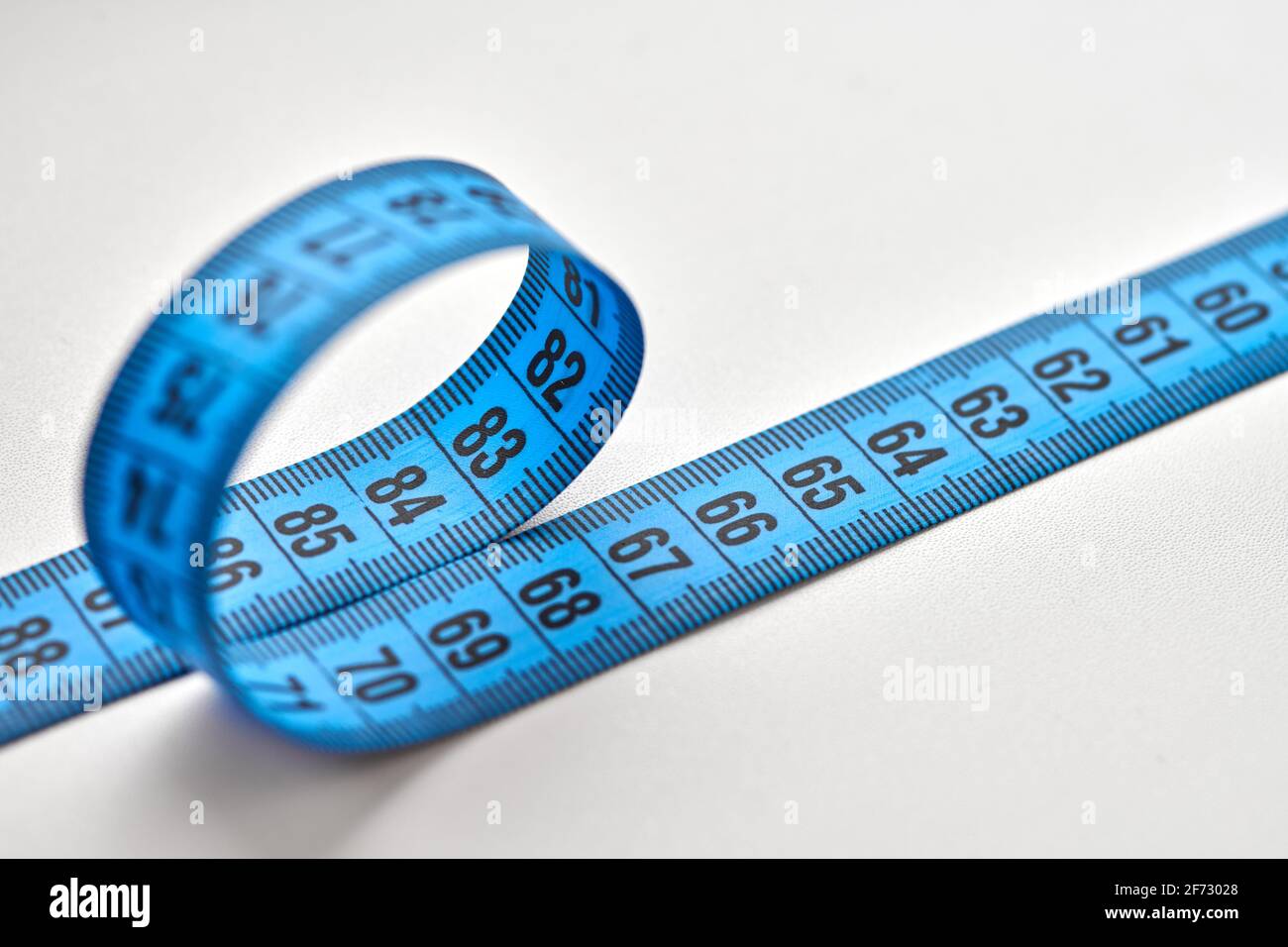 Blue measuring tape of tailor isolated on white background Stock Photo ...