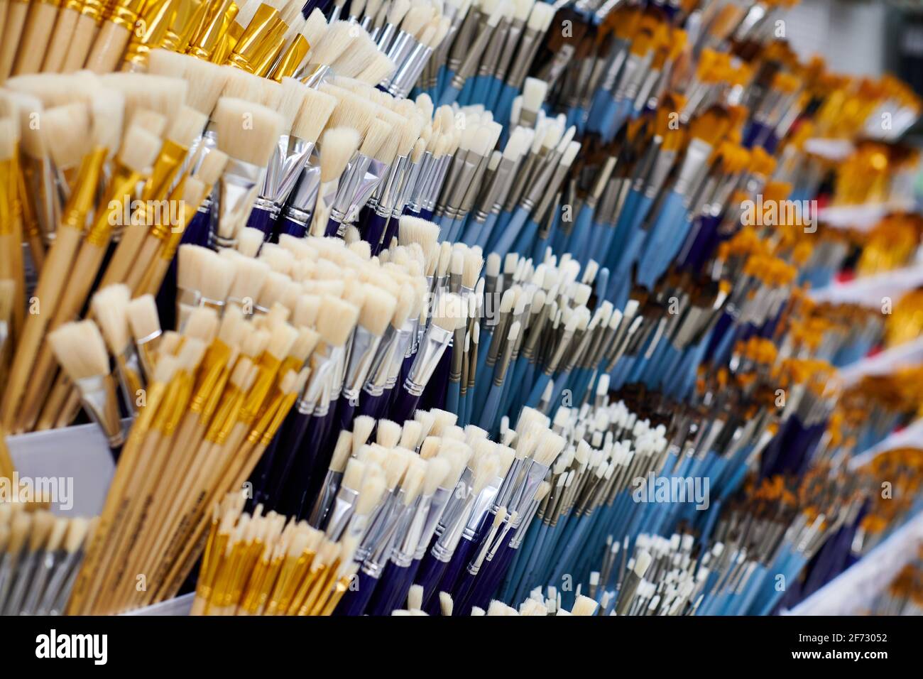 New artistic paintbrushes on shelf display in stationery shop, close up ...