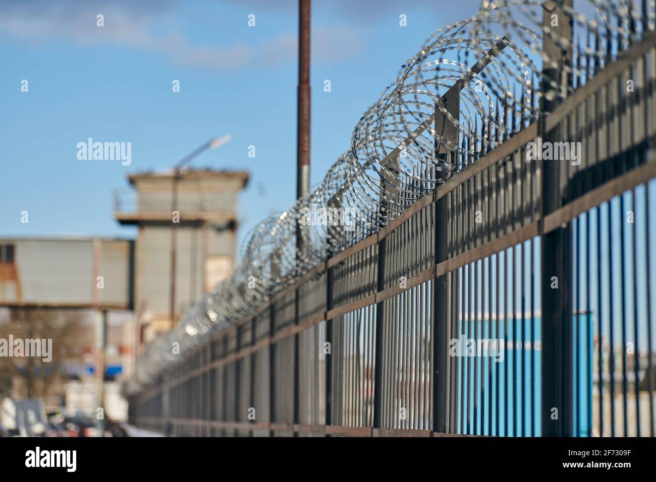 Barbed wire on fence, steel grating fence, metal fence wire. Coiled ...