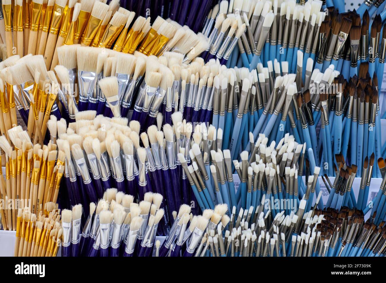 New artistic paintbrushes on shelf display in stationery shop, close up ...