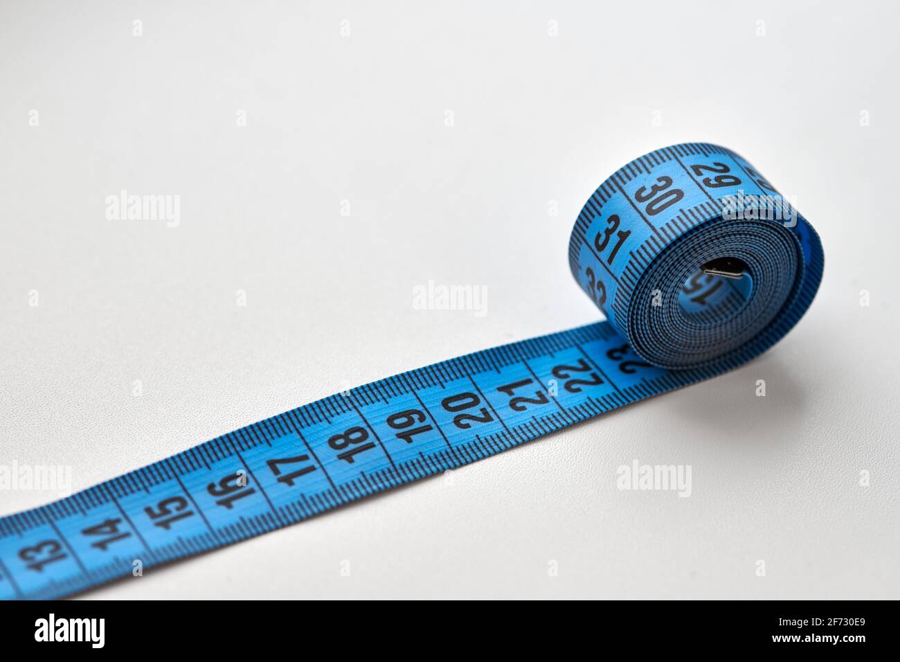 Blue measuring tape of tailor isolated on white background Stock Photo ...