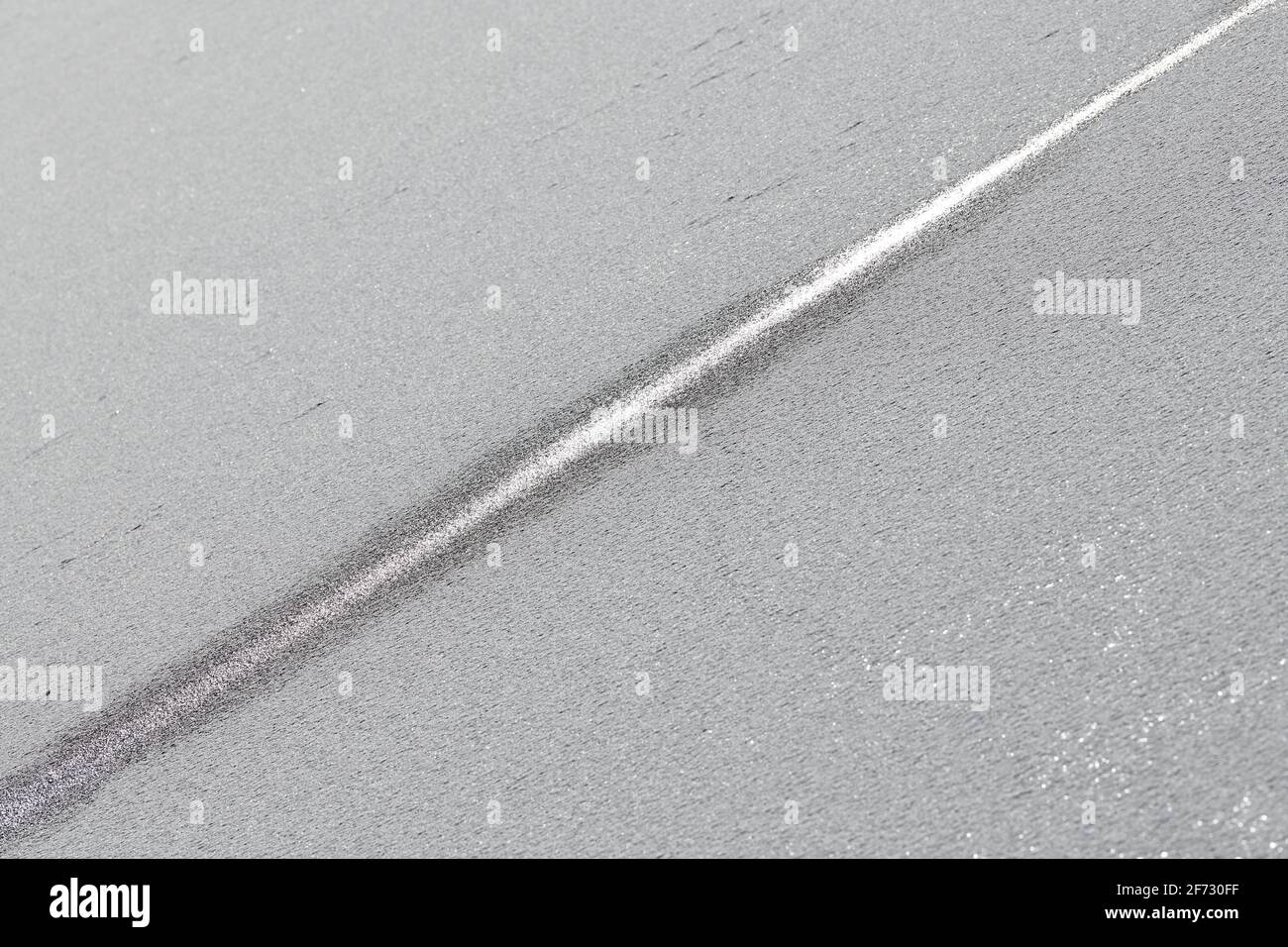 Diagonal line on cracked ice of frozen river with white snow. Ice ...