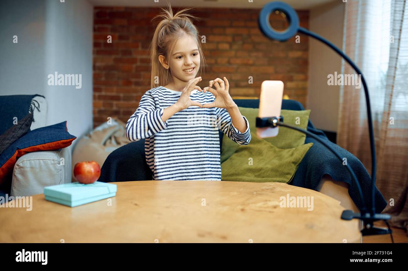Little girl records vlog on camera, child blogger Stock Photo - Alamy