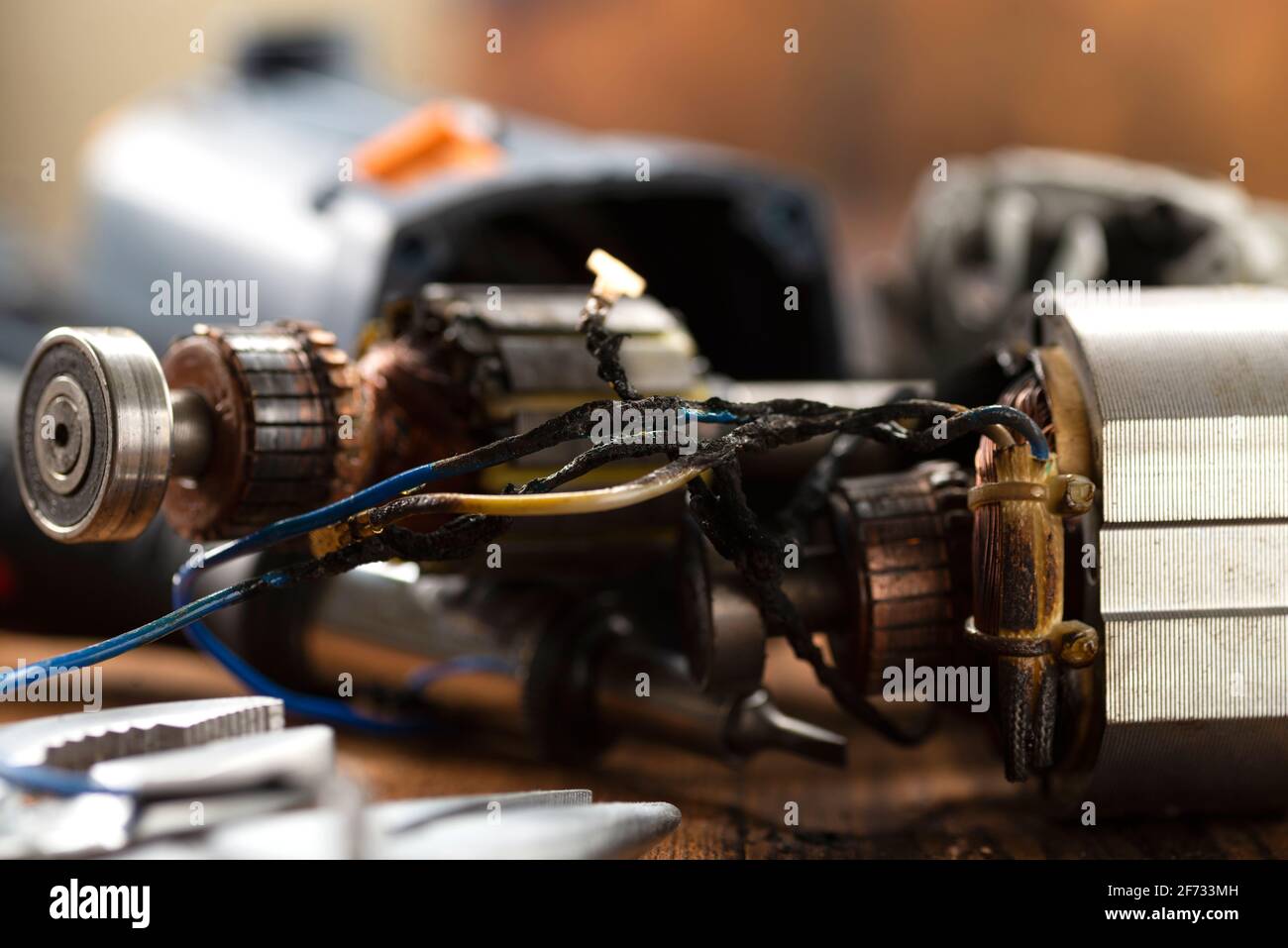 Burning wires on the details of an electrical appliance on a wooden ...