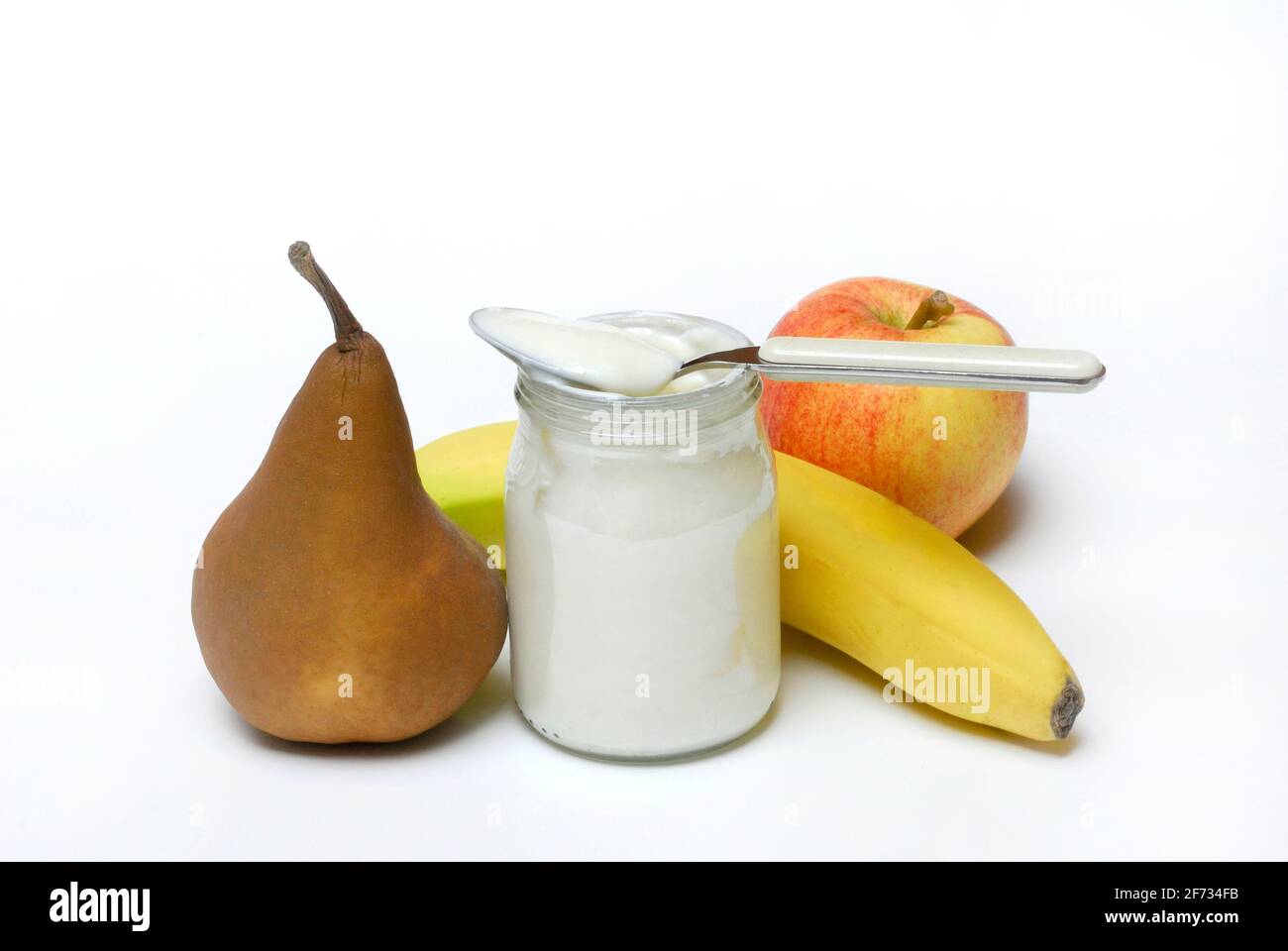 Glass of yoghurt, apple, pear and banana, dairy products, spoon Stock ...