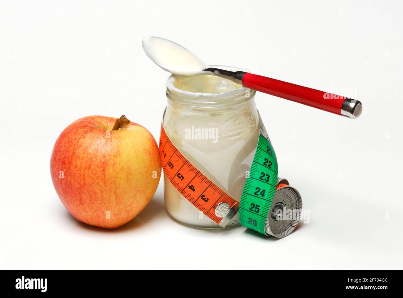 Glass of yoghurt, apple and tape measure, dairy products Stock Photo ...