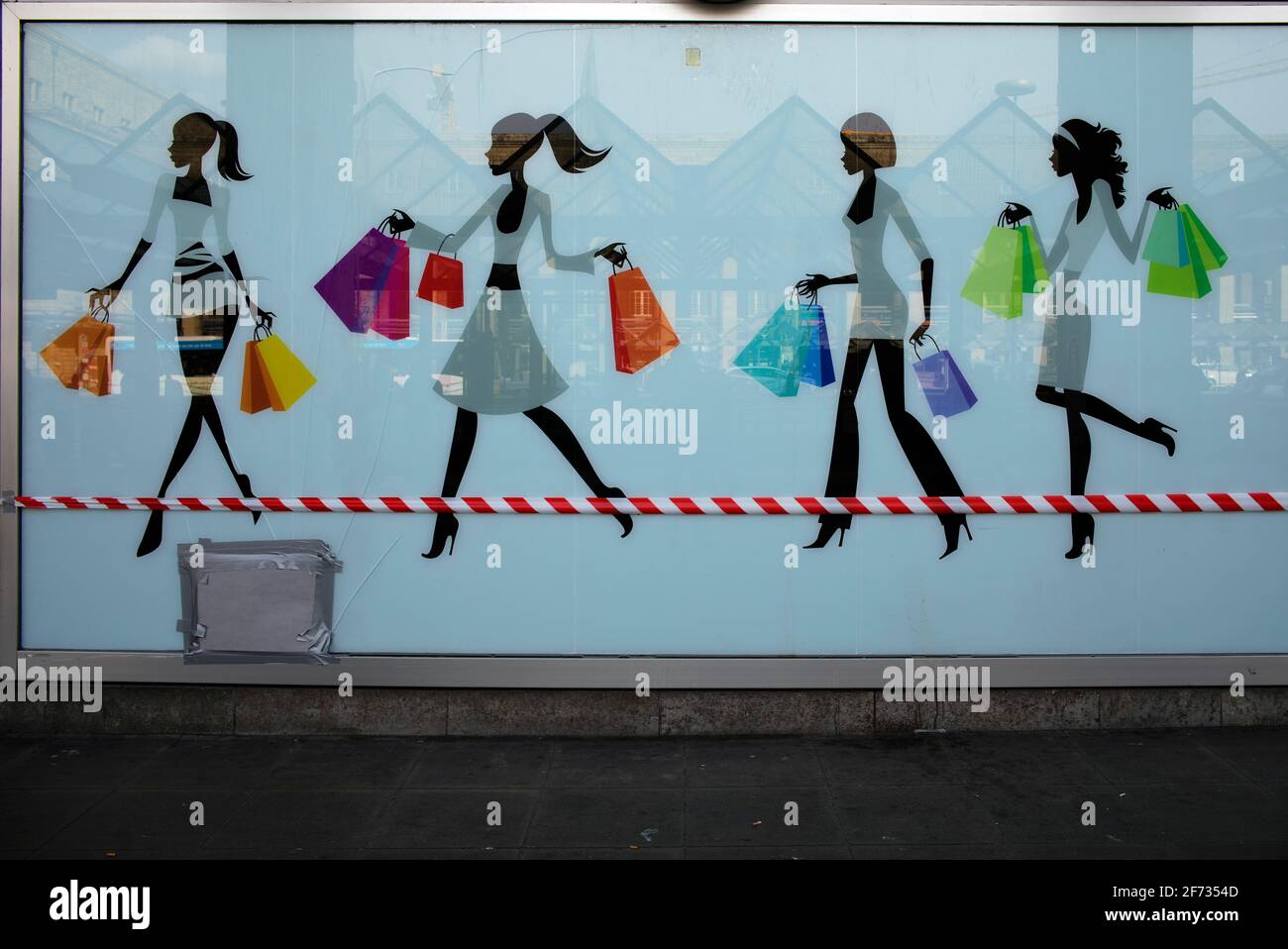 Closed fashion store, red and white banderole in front of shop window ...