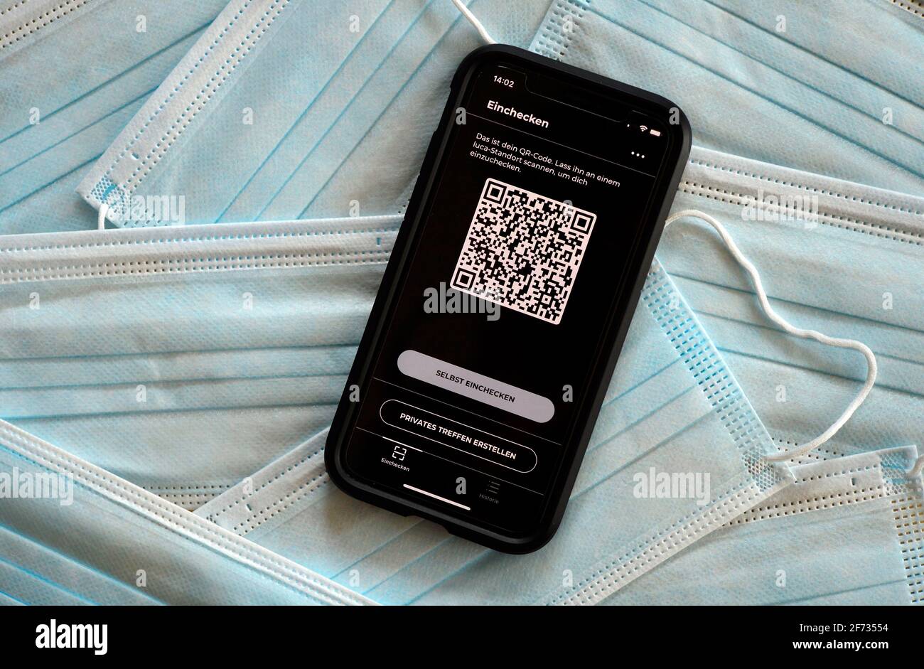 Luca app with QR code lies on mouth masks, Corona crisis, Germany Stock ...