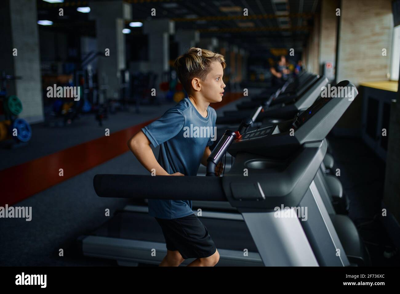 Boy doing exercise on treadmill, running machine Stock Photo - Alamy