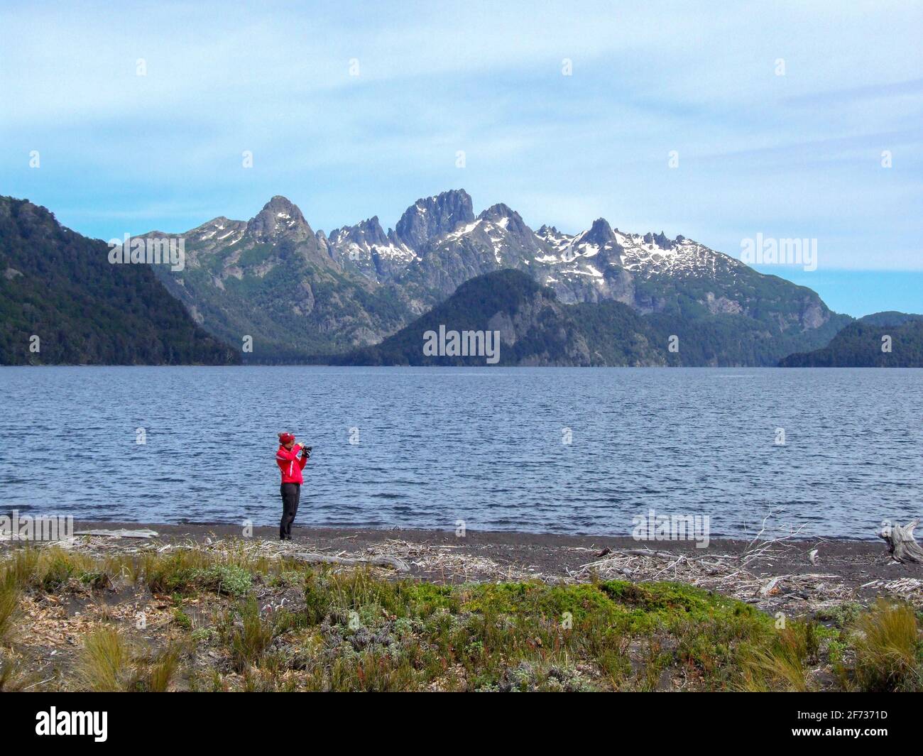 woman taking pictures at lago Tromen lake, Lanin national park, against ...
