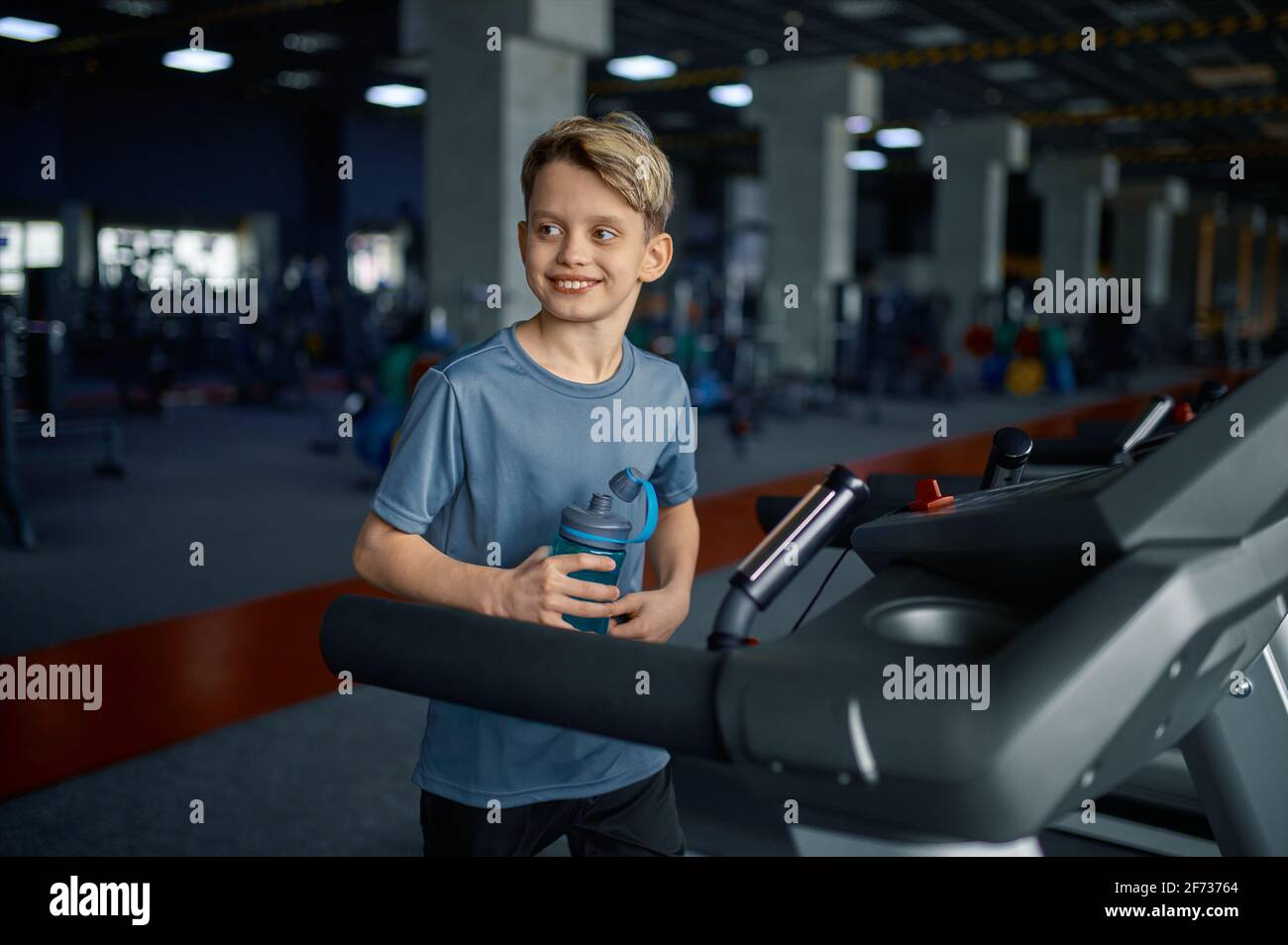 Boy doing exercise on treadmill, running machine Stock Photo - Alamy